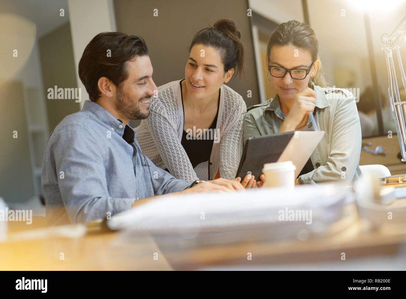 Colleagues workshopping business ideas in modern co working space Stock ...