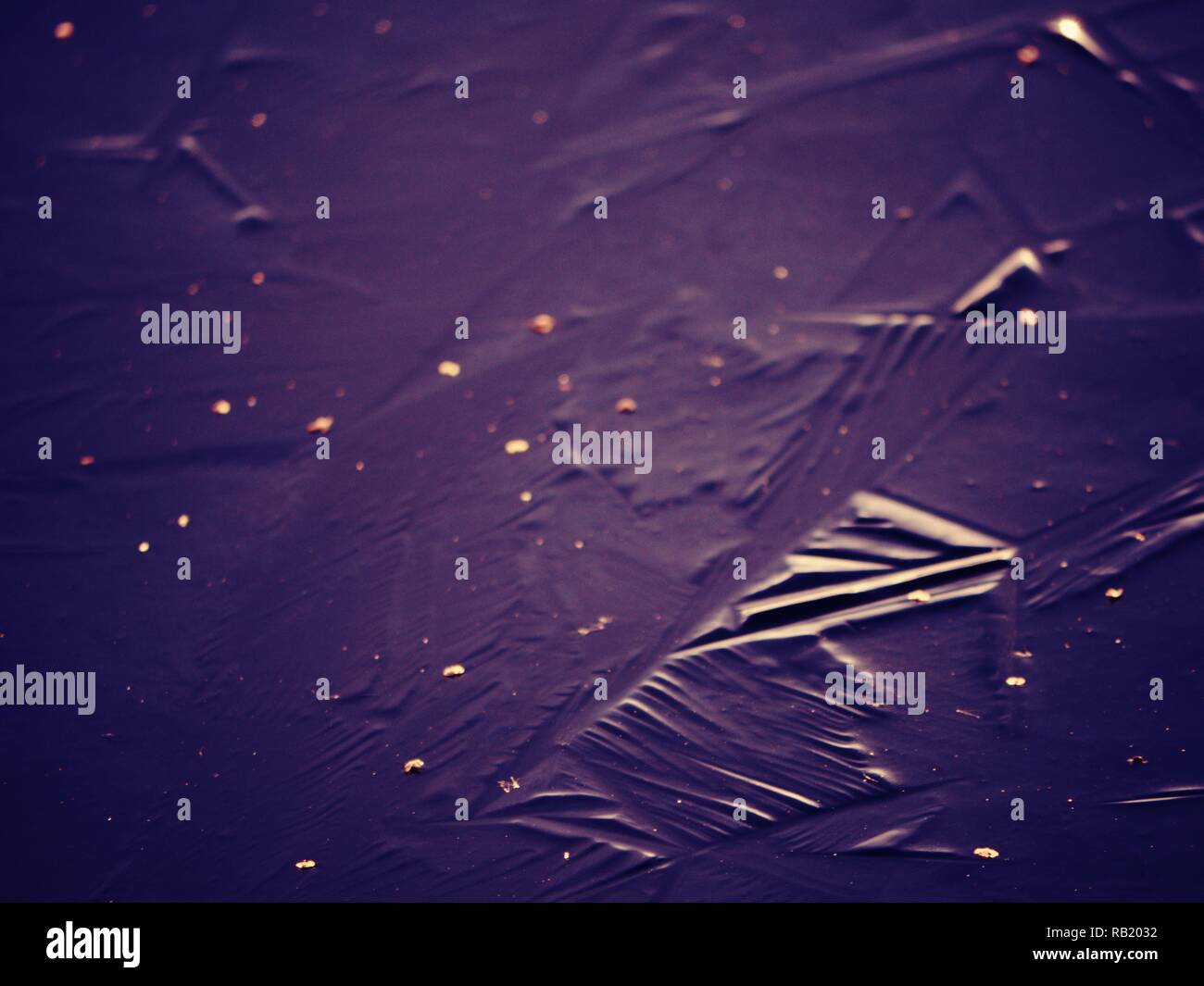 Dark ice with evening sun flares. Nature art with small depth of field ...