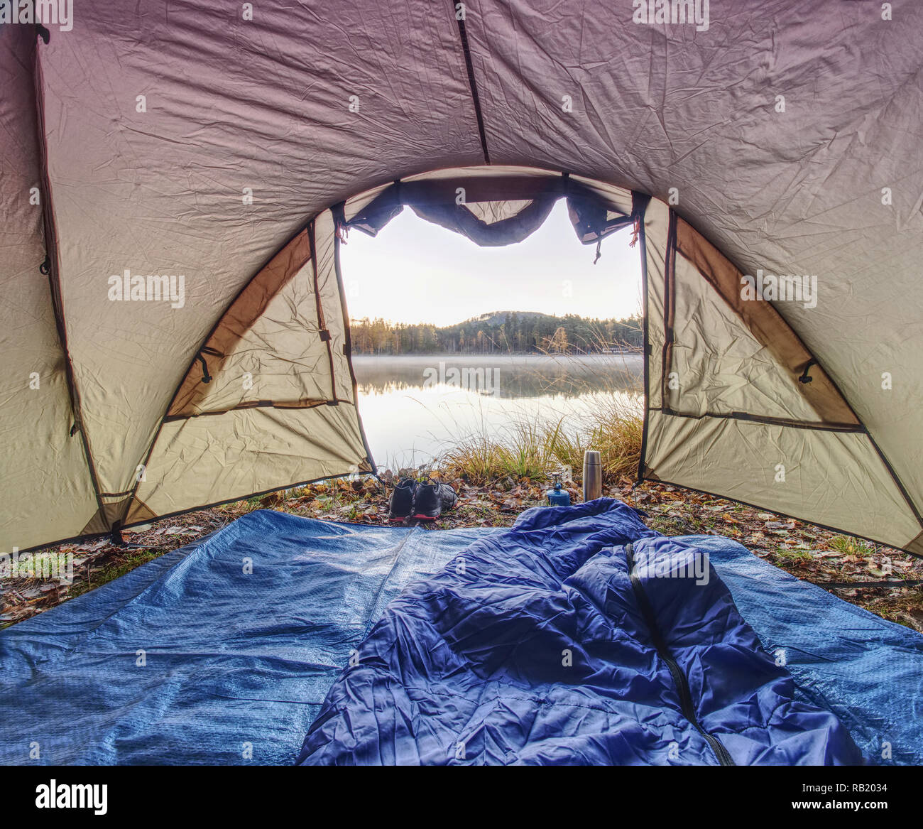 Tent on romantic place at lake shore. Colorful fall forest. Hilly ...
