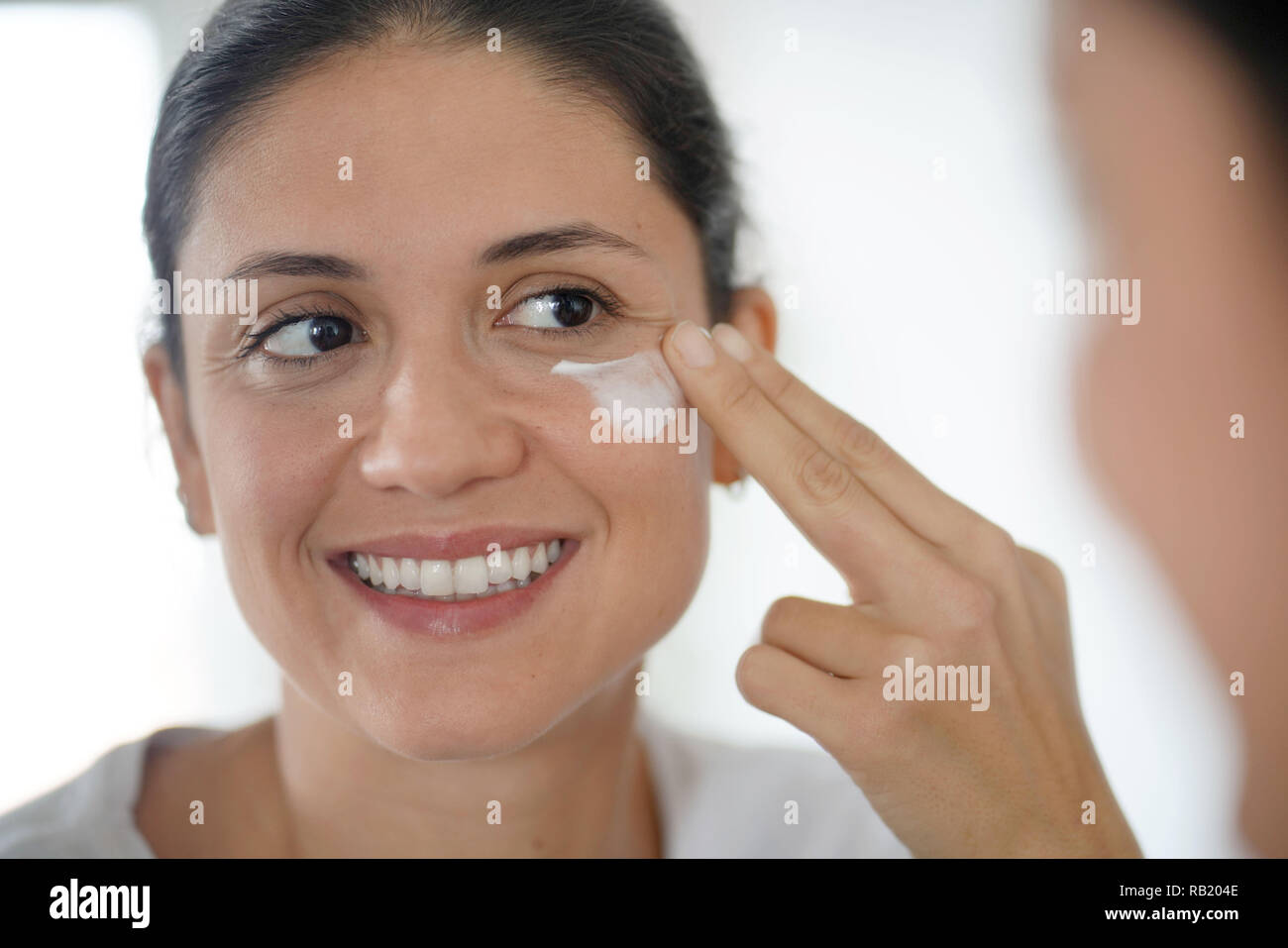 Beautiful brunette going through beauty routine Stock Photo - Alamy