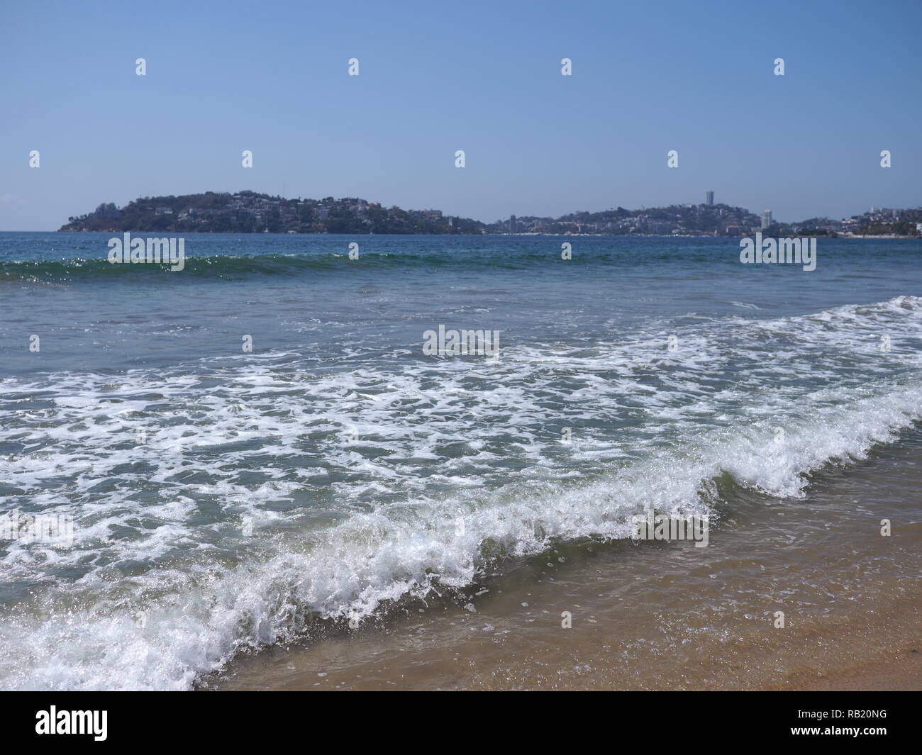 Scenery of desolate beach at bay of ACAPULCO city in Mexico and white ...