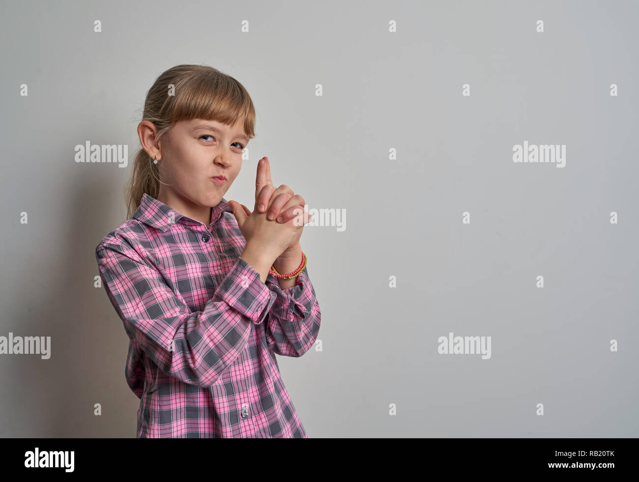 little girl grimacing on white background Stock Photo - Alamy