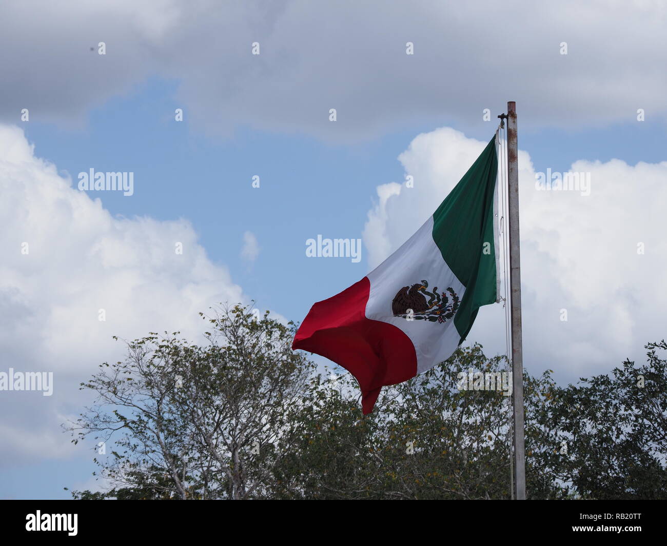 National maxican flag at Chichen Itza city near wonderful ...