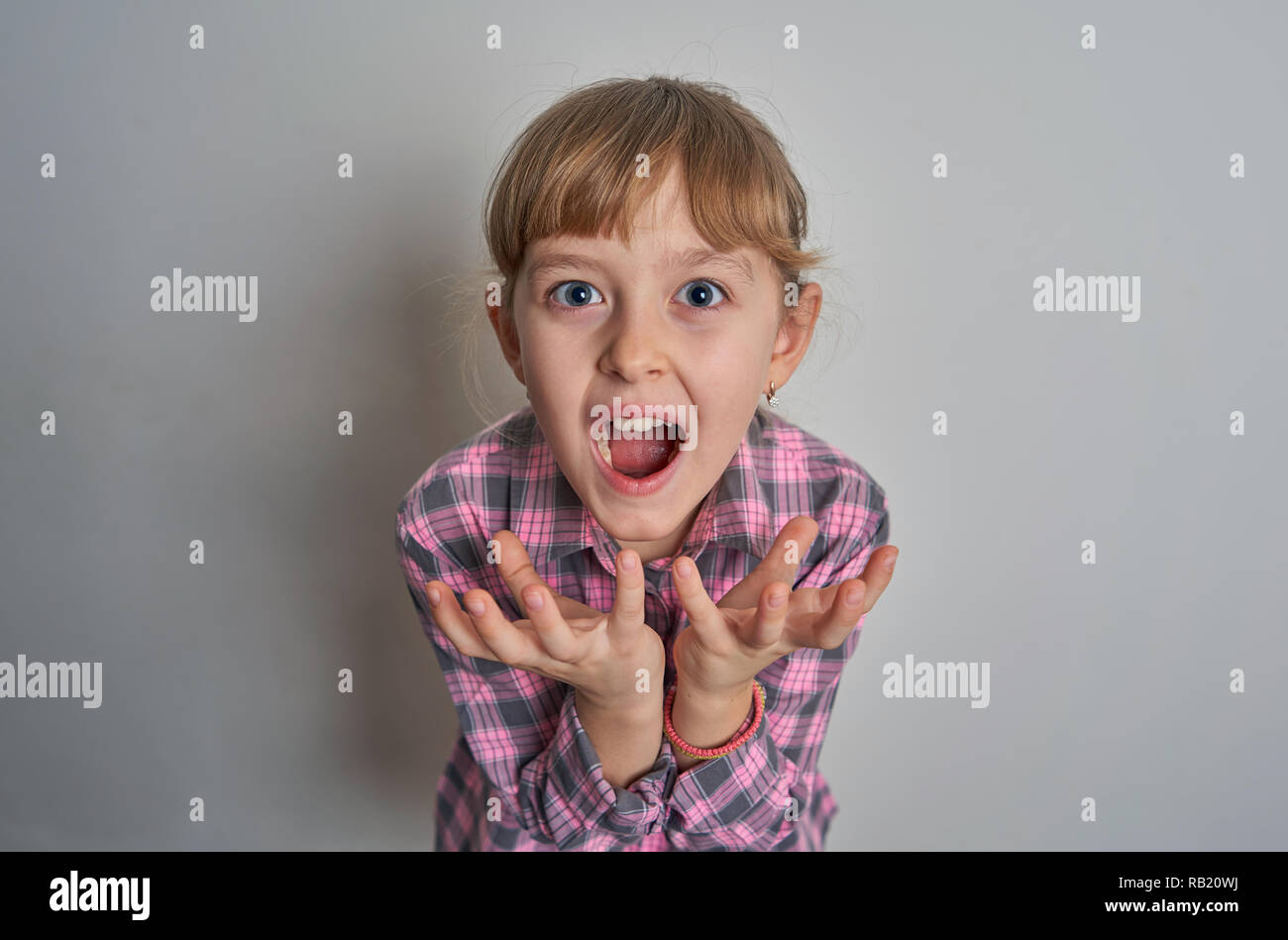 little girl grimacing on white background Stock Photo - Alamy