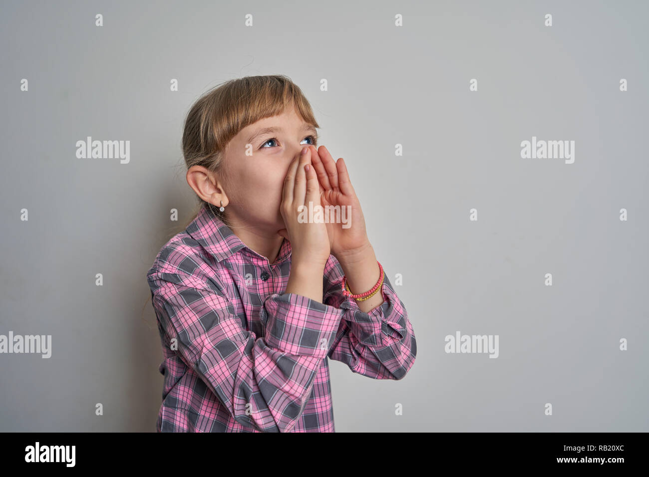 little girl grimacing on white background Stock Photo - Alamy