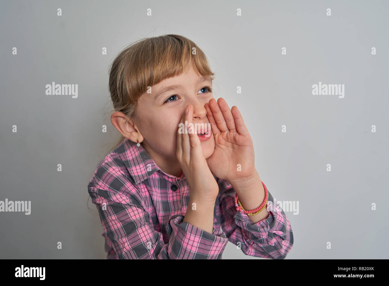 little girl grimacing on white background Stock Photo - Alamy