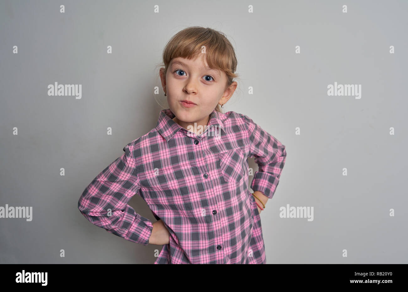 little girl grimacing on white background Stock Photo - Alamy