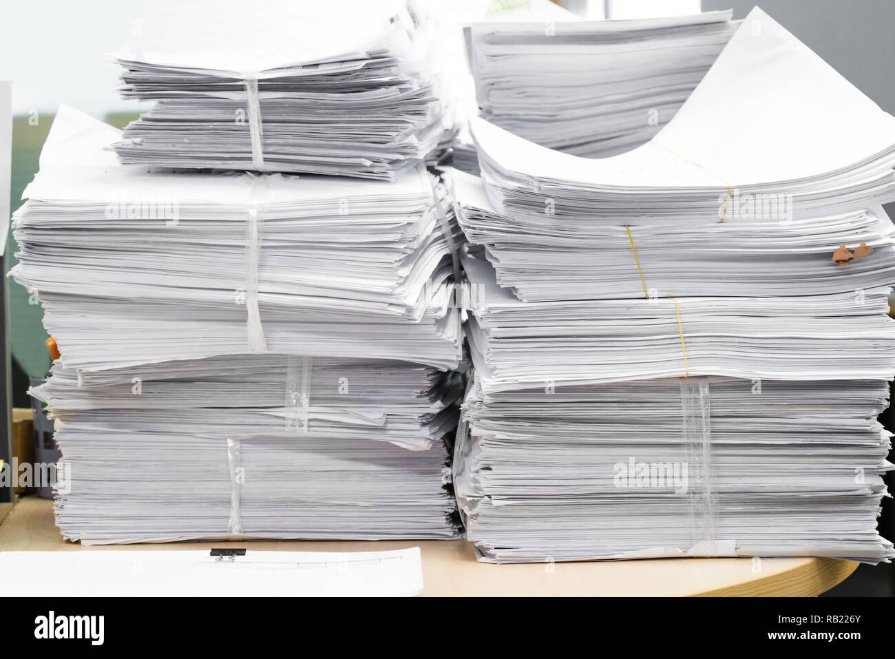 Paper heap from hard work, useless paper Stock Photo - Alamy