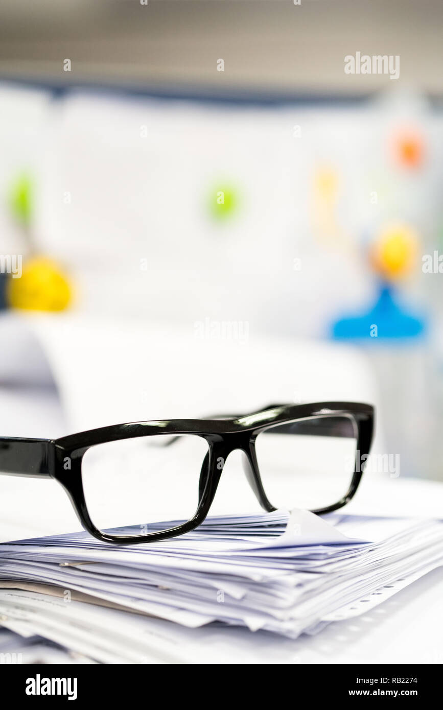 Paper heap from hard work is under black glass Stock Photo - Alamy