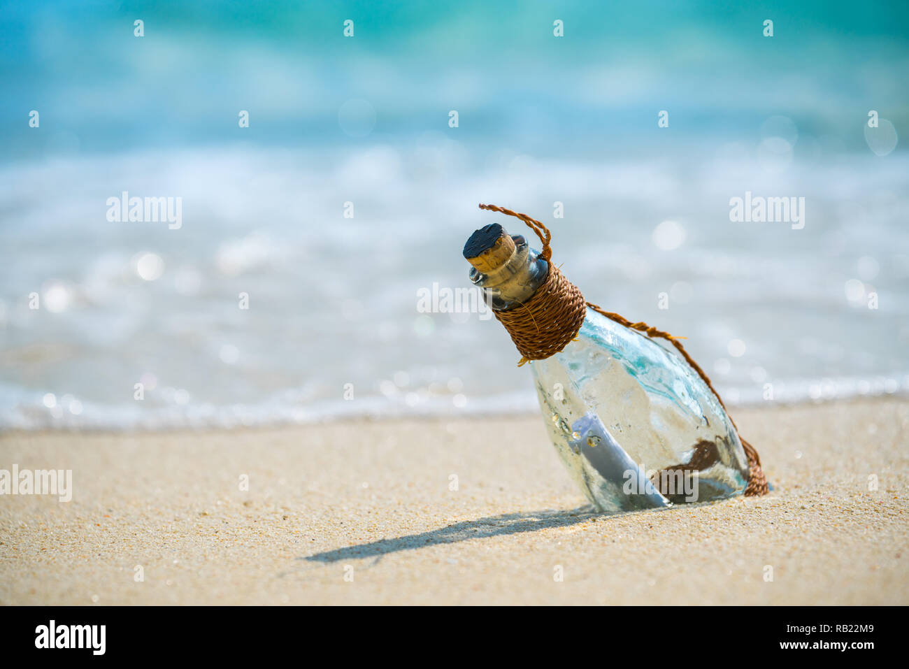 Letter message in a glass transparent bottle on the beach , concept for ...