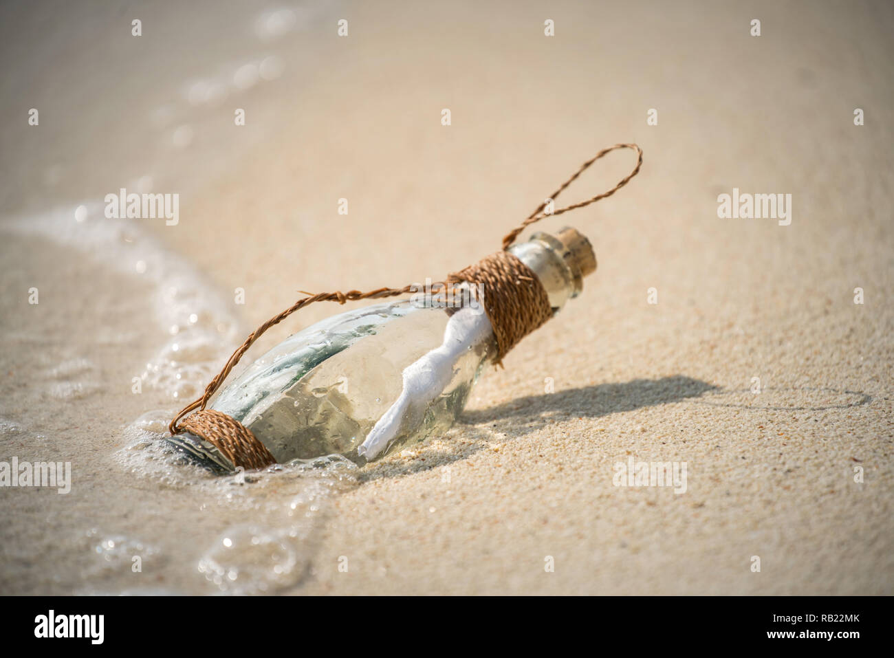 Letter message in a glass transparent bottle on the beach , concept for ...