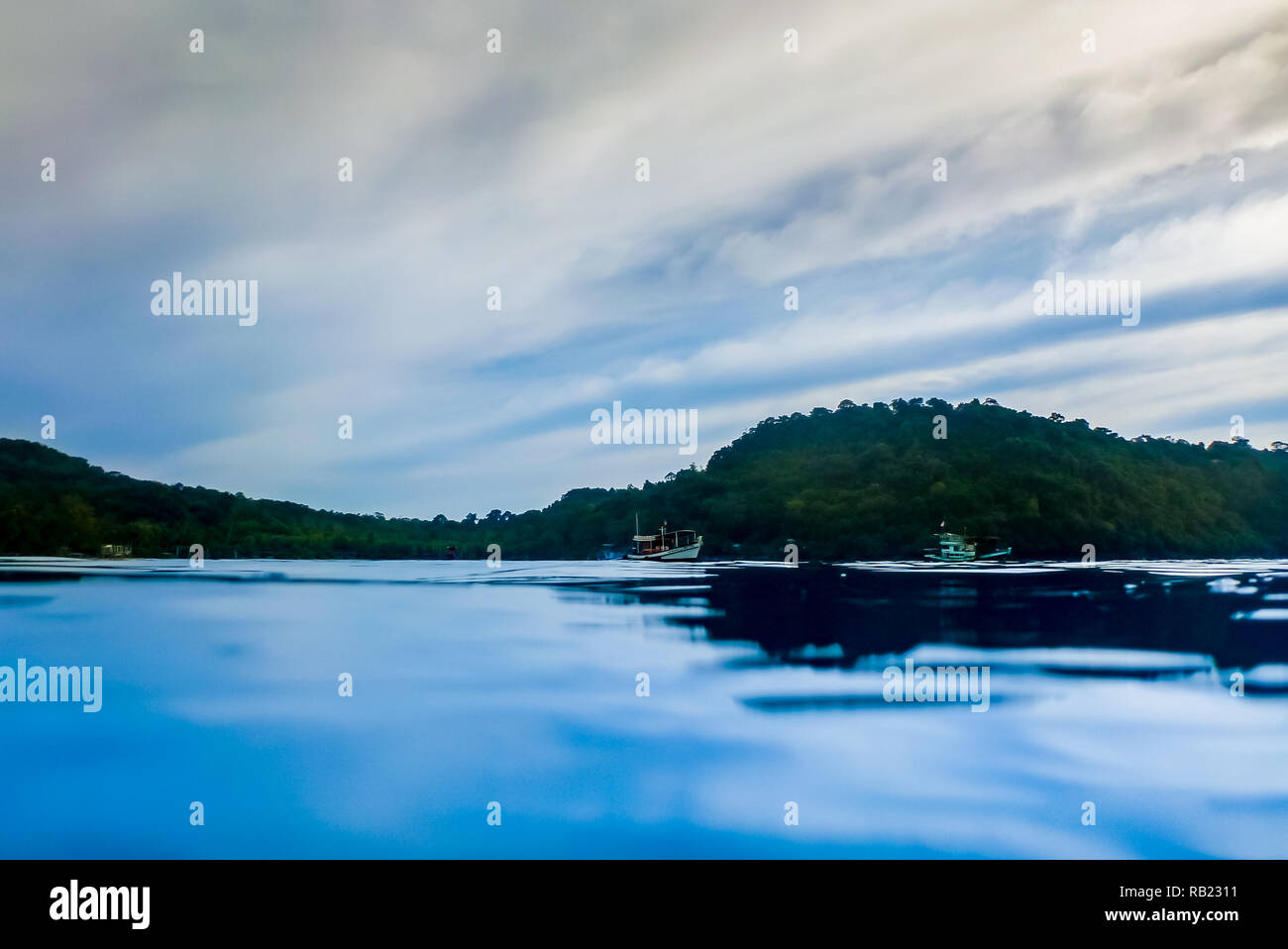 tropical island taken from waterline, water level photo Stock Photo - Alamy