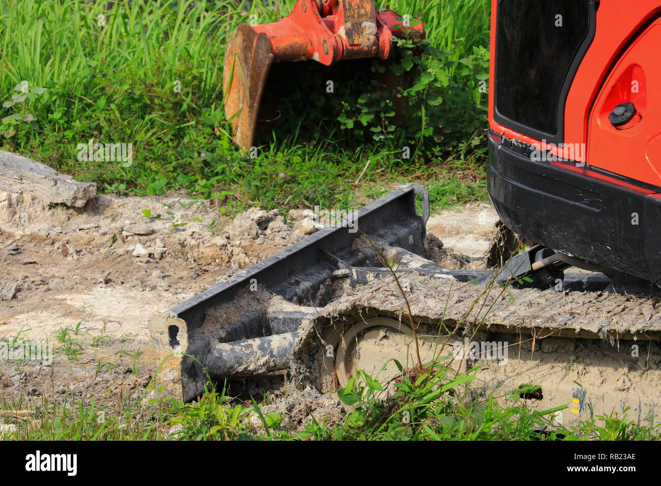 bucket small excavator orange crawler bulldozer in working Stock Photo ...