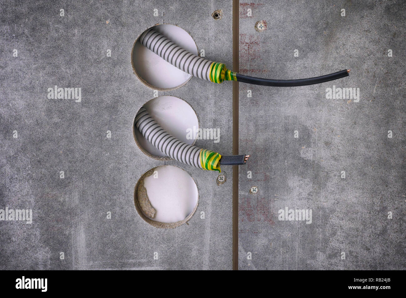 Plastic corrugated pipes with electric cable inside sticking out of ...