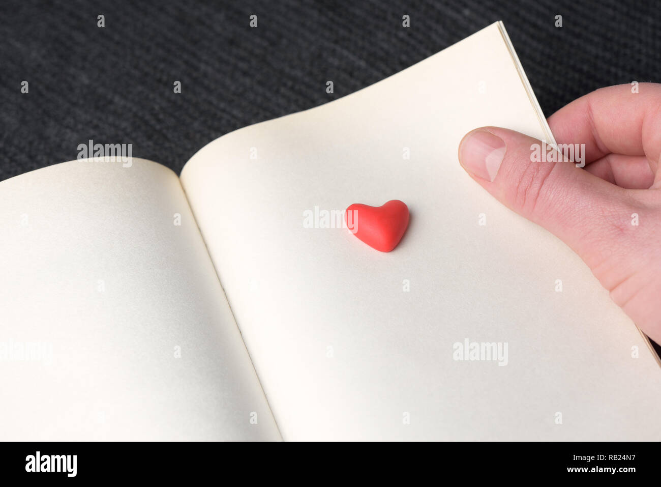 Decorative heart on a book page. Symbol of love Stock Photo - Alamy