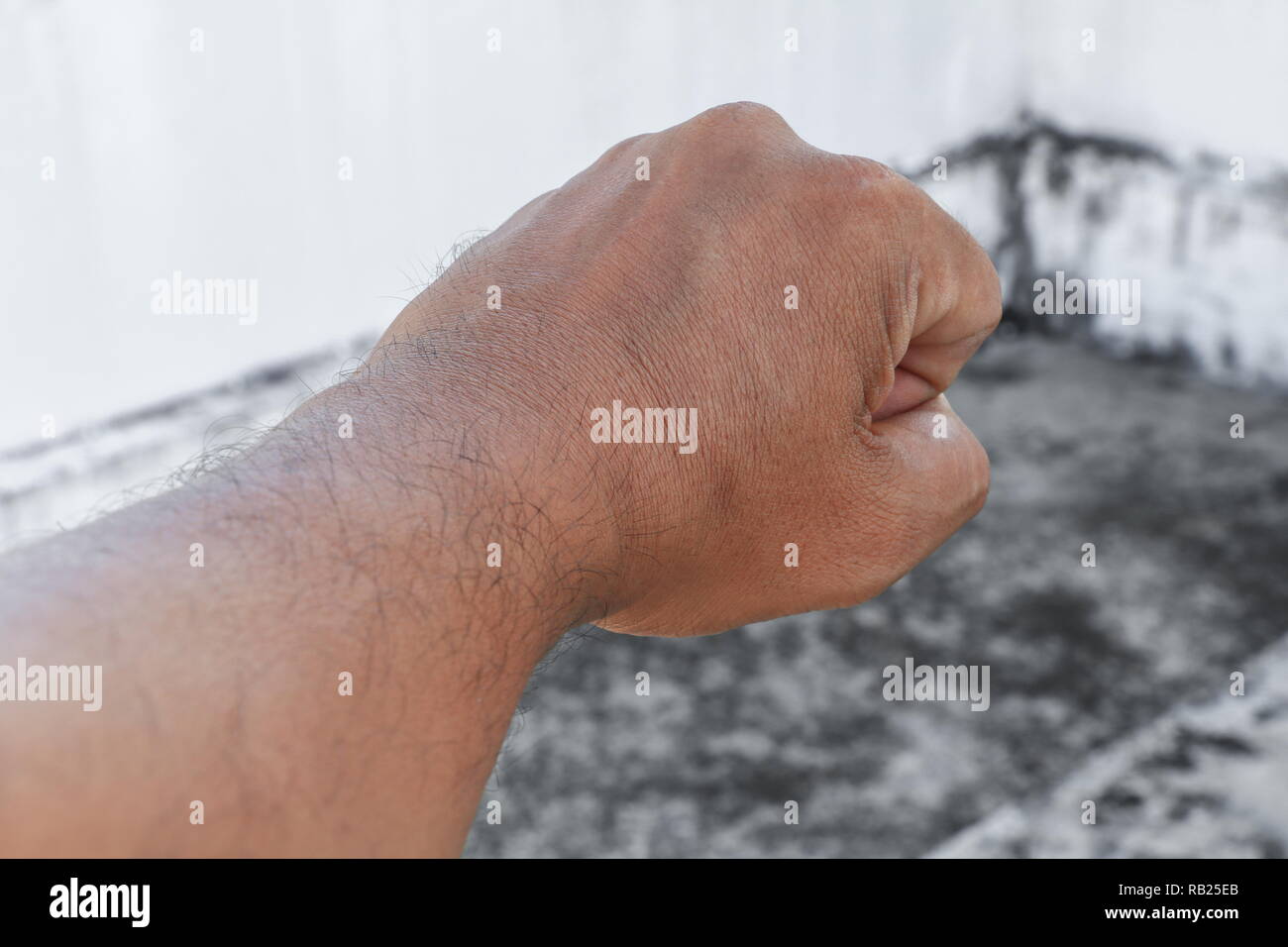 hand fist on blurred background Stock Photo - Alamy