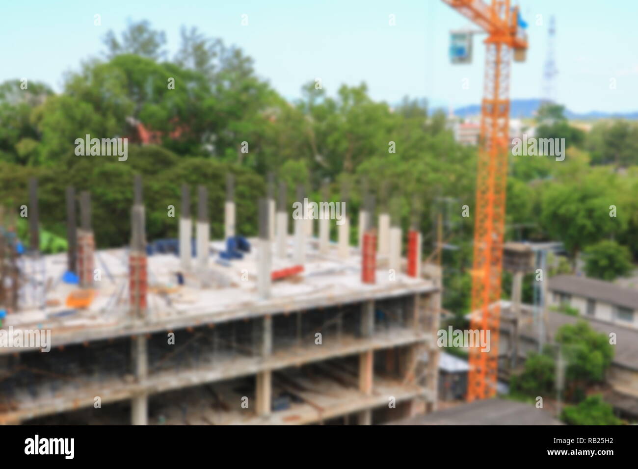 blurred construction worker. and crane building commercial in site ...