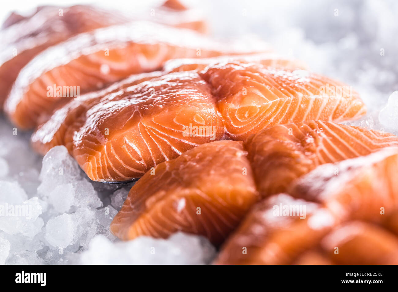 Salmon fillets portioned on ice and empty kitchen board Stock Photo - Alamy