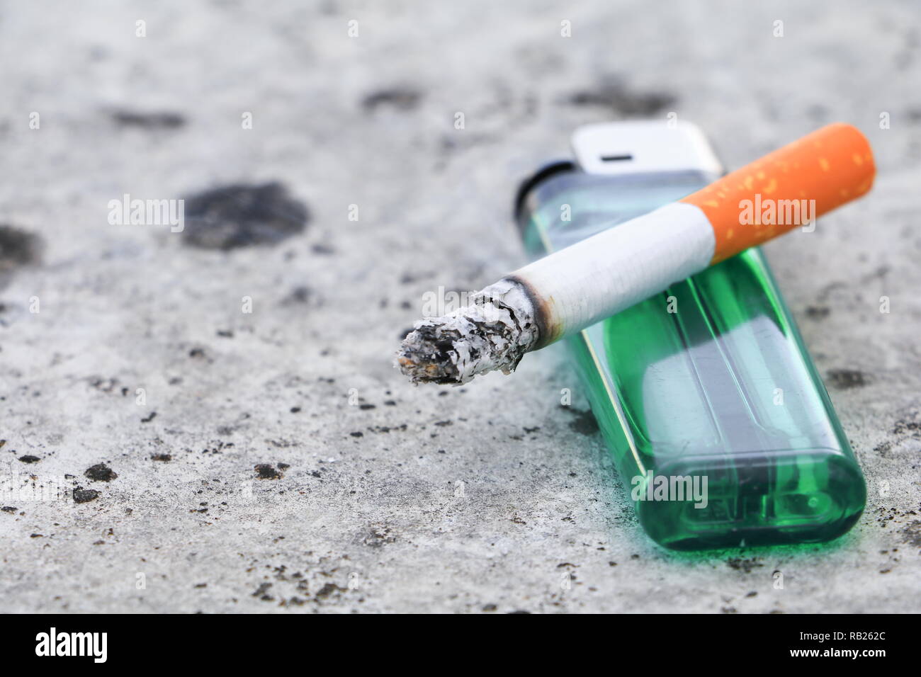 cigarette burn and lighter on floor concrete background. concept Non ...