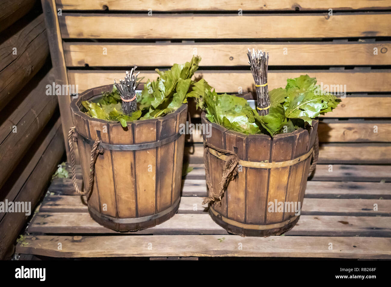 Birch broom in a wooden bucket in the bathhouse Stock Photo - Alamy