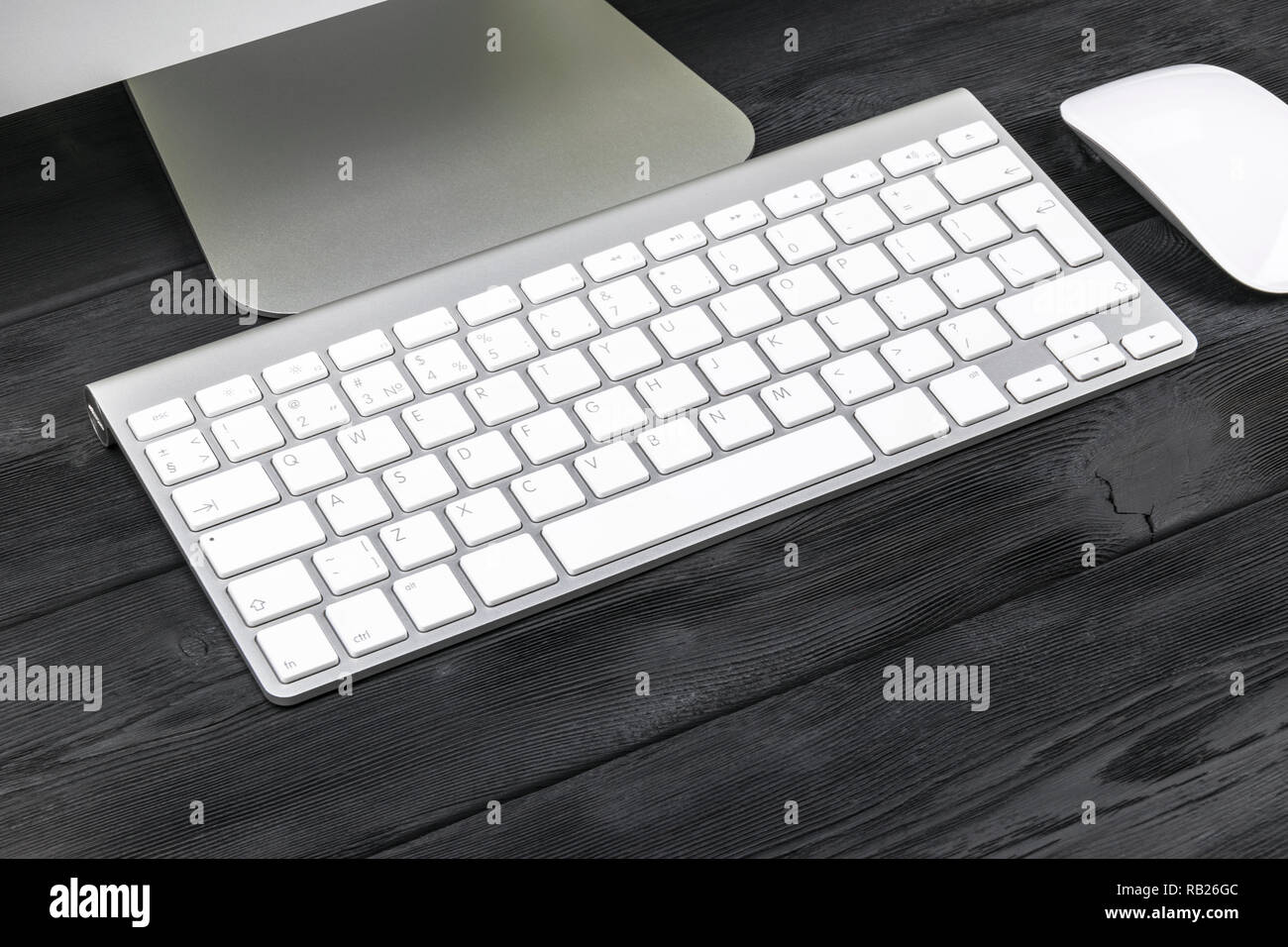 Business workplace with computer, wireless keyboard and mouse on black ...