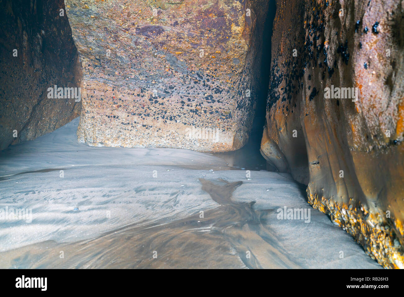 Aged weather and sea worn rock cave walls showing years of effects of ...