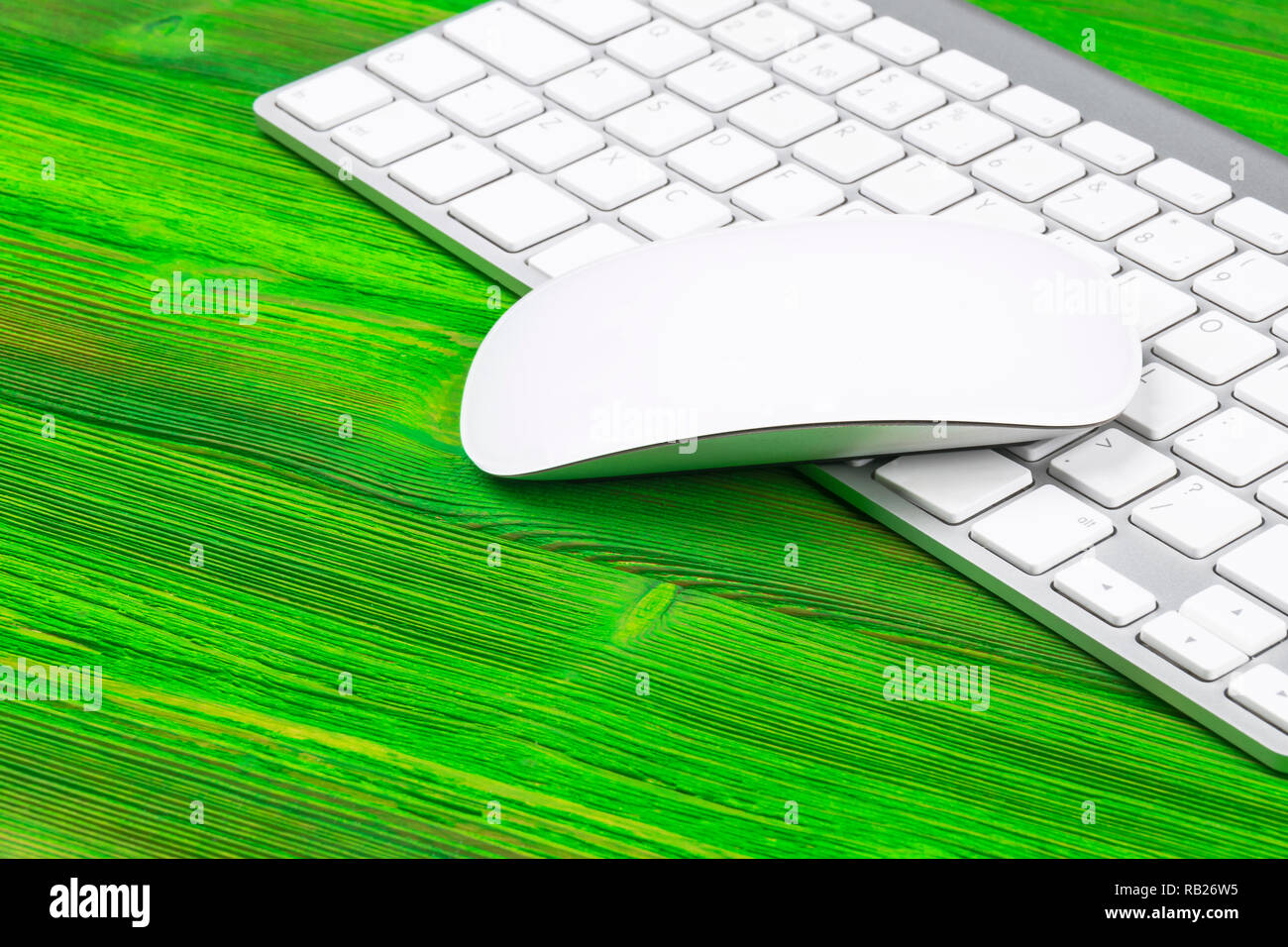 Business workplace with computer, wireless keyboard, keys on old green ...