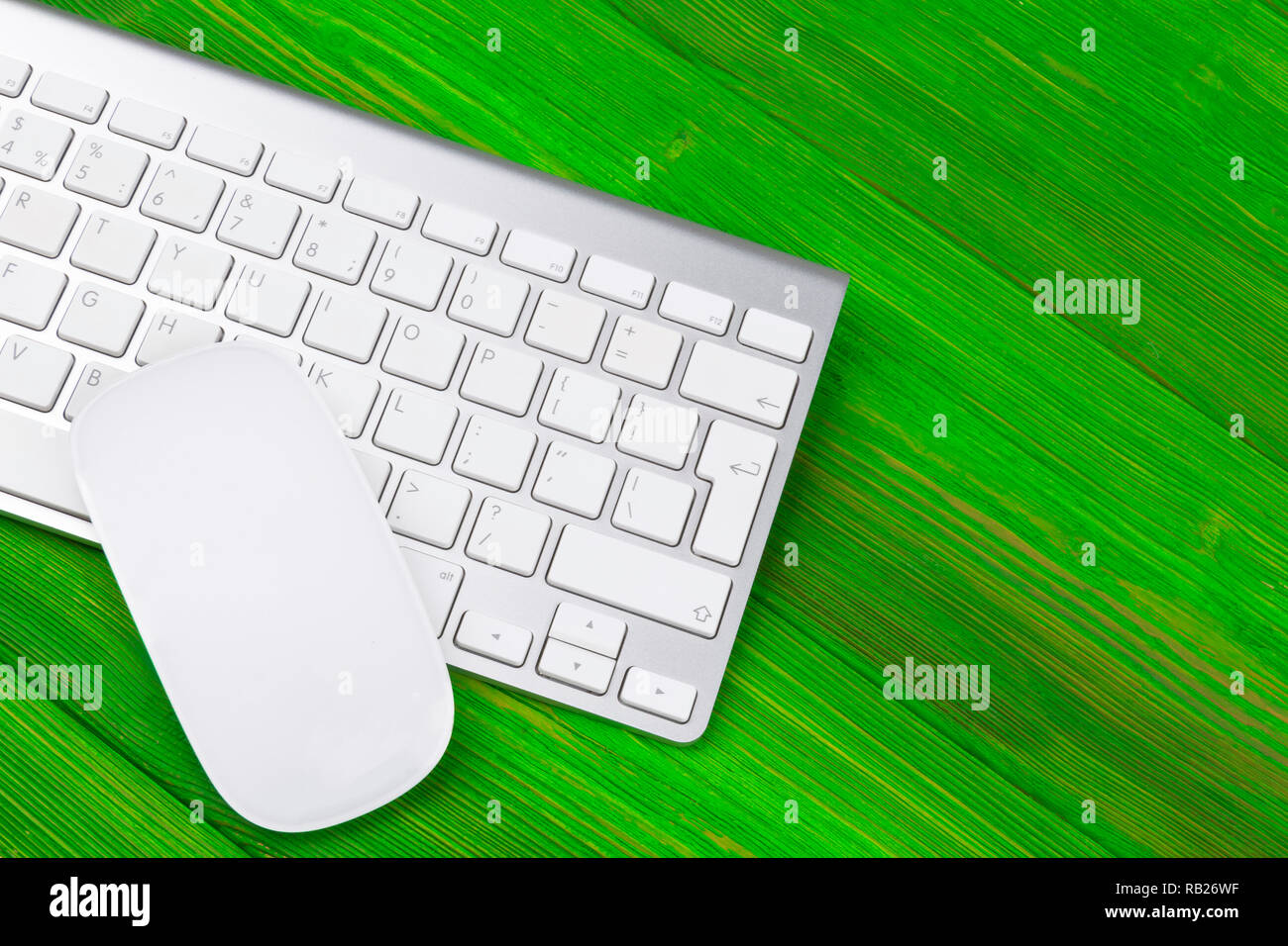 business workplace with computer, wireless keyboard, keys and mouse on ...