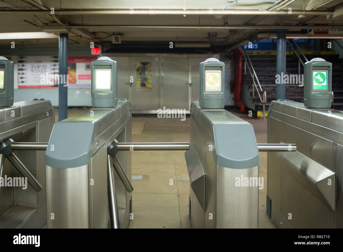 Turnstiles with no people walking in the station showing commute. th ...