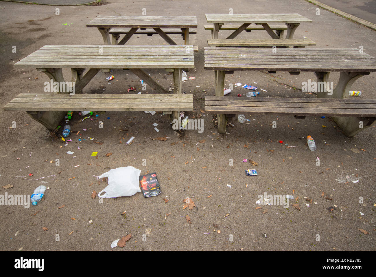 Littered rubbish around park benches Stock Photo - Alamy