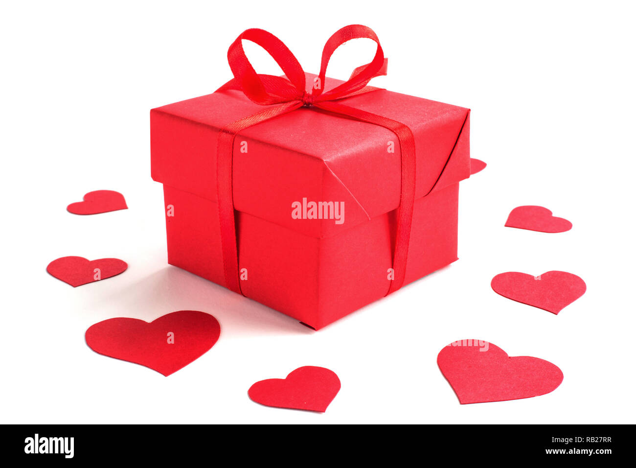 Small red gift box with ribbon bow and paper hearts studio isolated on ...