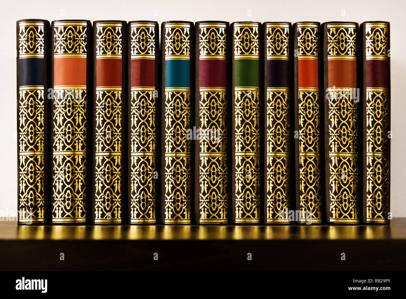 Antique looking books with golden decoration and colorful bands on a ...