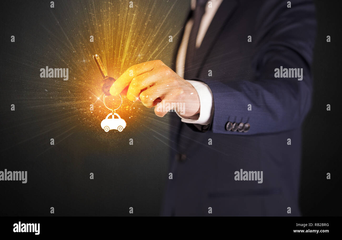 Formal man hand over shiny keys with dark background Stock Photo - Alamy