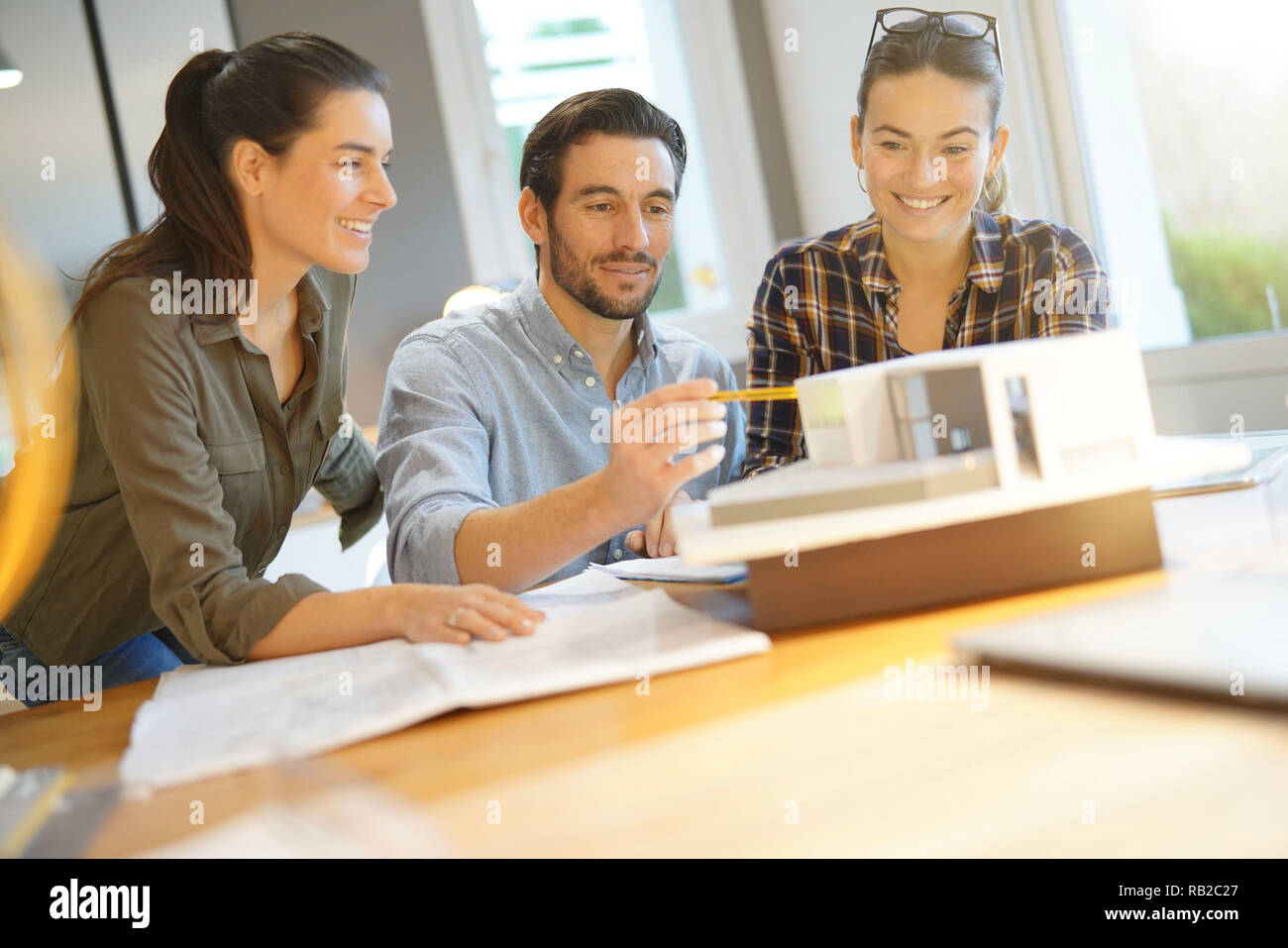 Architects looking over project for modern house design Stock Photo - Alamy