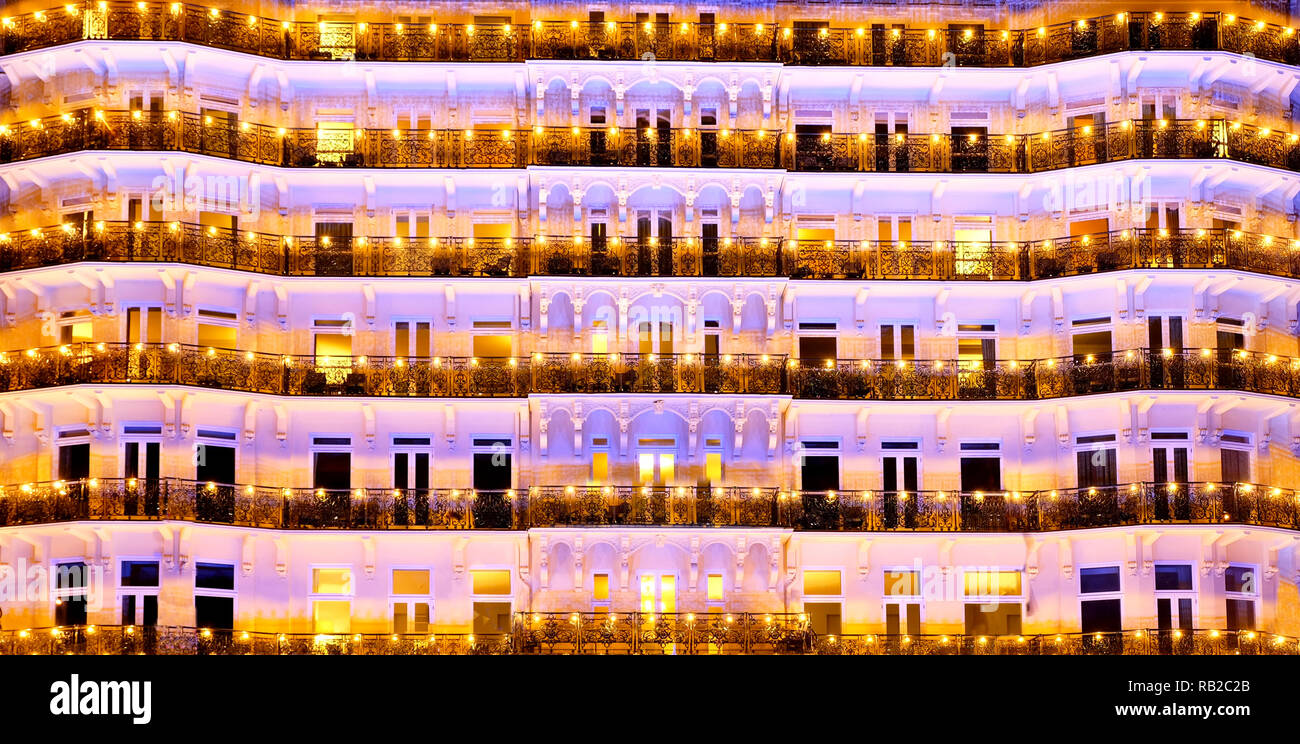 The repeating patterns of the front of a white grand regency hotel pink ...