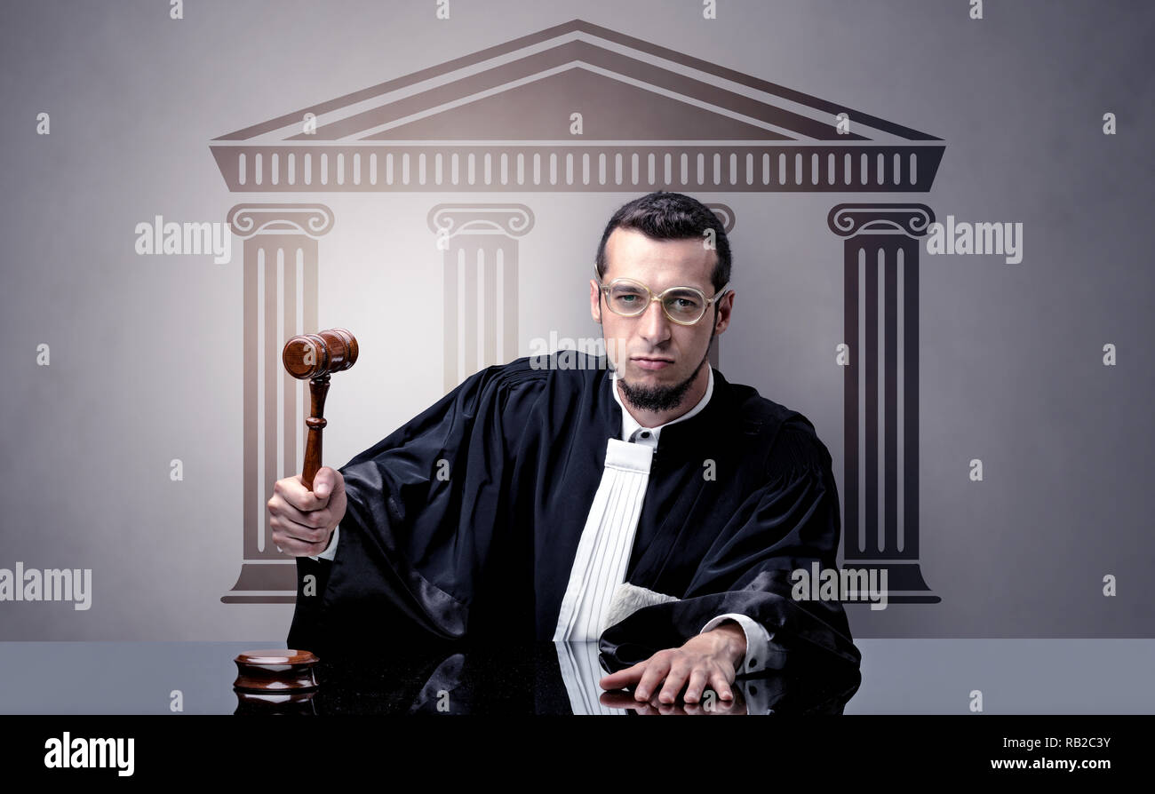 Young judge in front of a courthouse symbol making decision Stock Photo ...