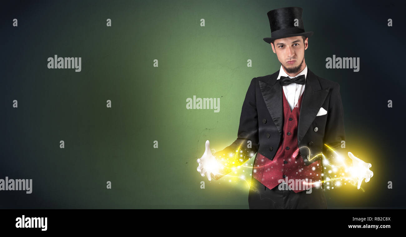Magician holding his sparkling power between his two hand Stock Photo ...