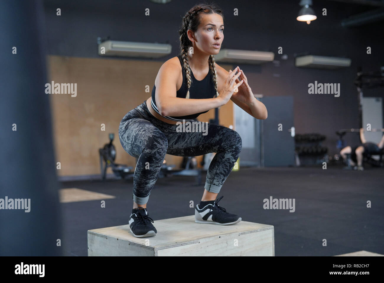 Adult brunette woman doing squats hi-res stock photography and images ...