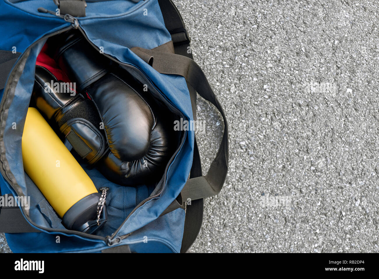 Preparing to fight. Close-up of sports bag and boxing gloves with water ...