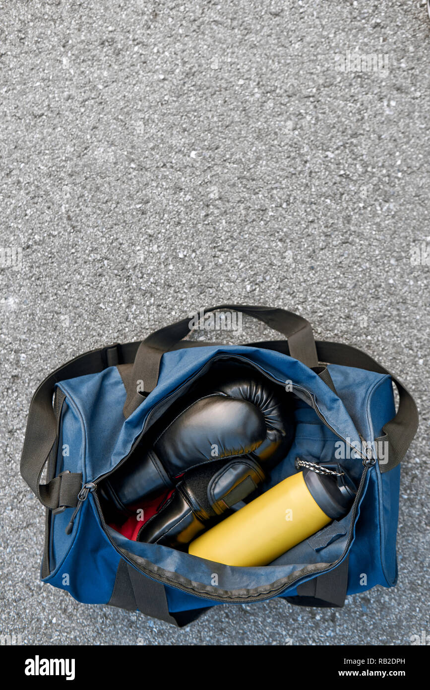 Preparing to fight. Top view of sports bag and boxing gloves with water ...