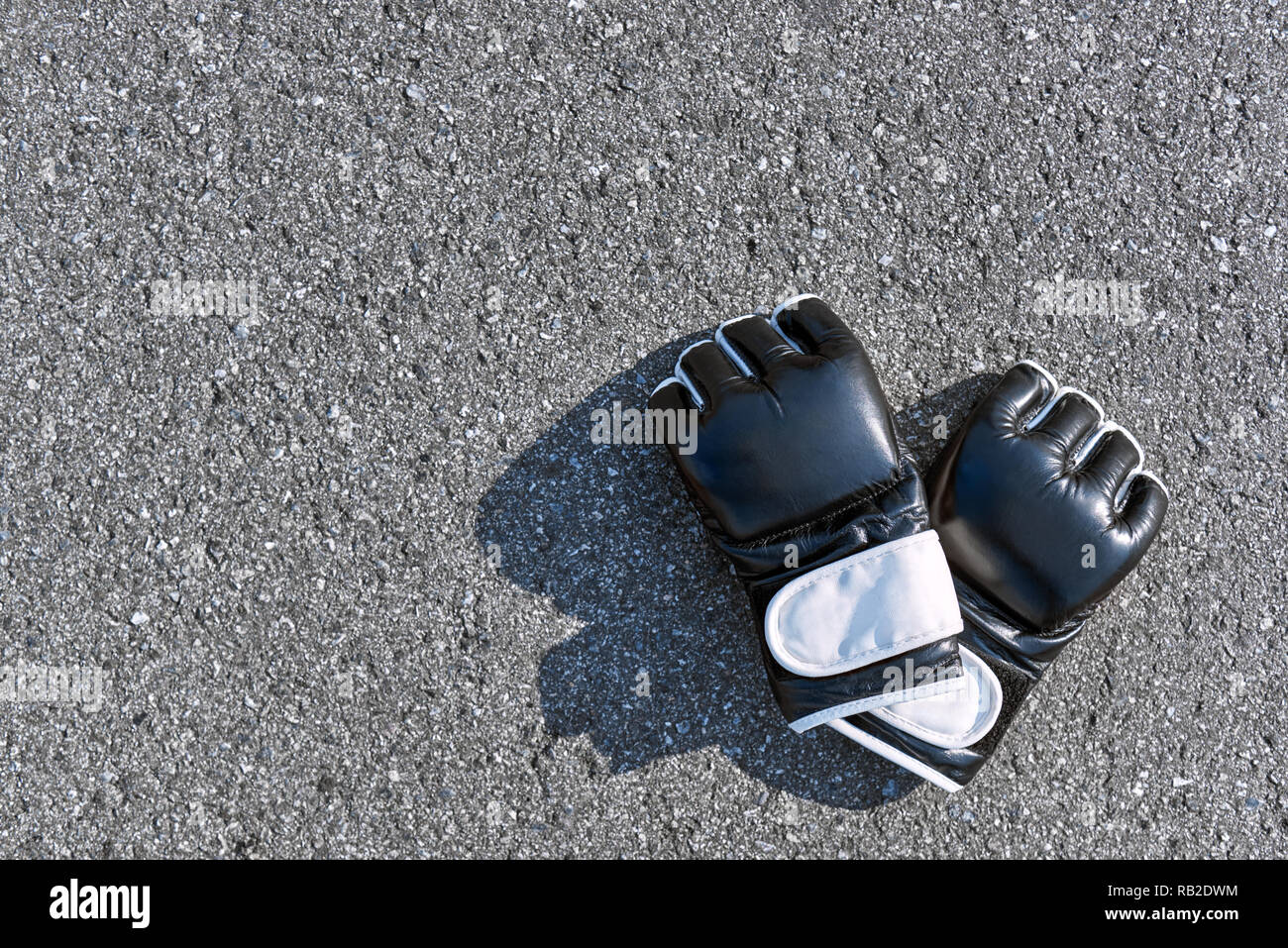 Boxing gloves. Close-up of sports boxing black gloves at the asphalt ...