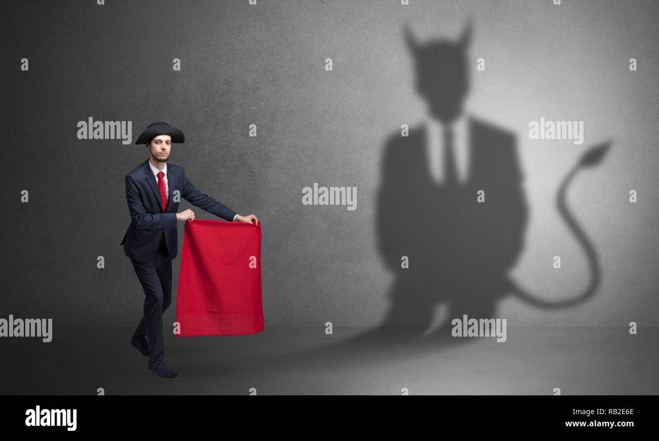 Businessman standing with red cloth in his hand and devil shadow on the ...