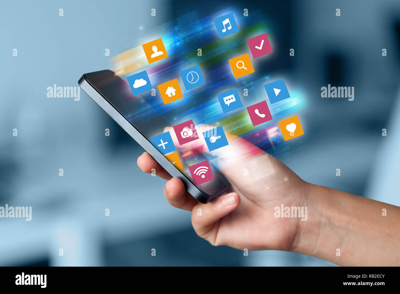 Hand using phone with colorful fast moving application icons and ...