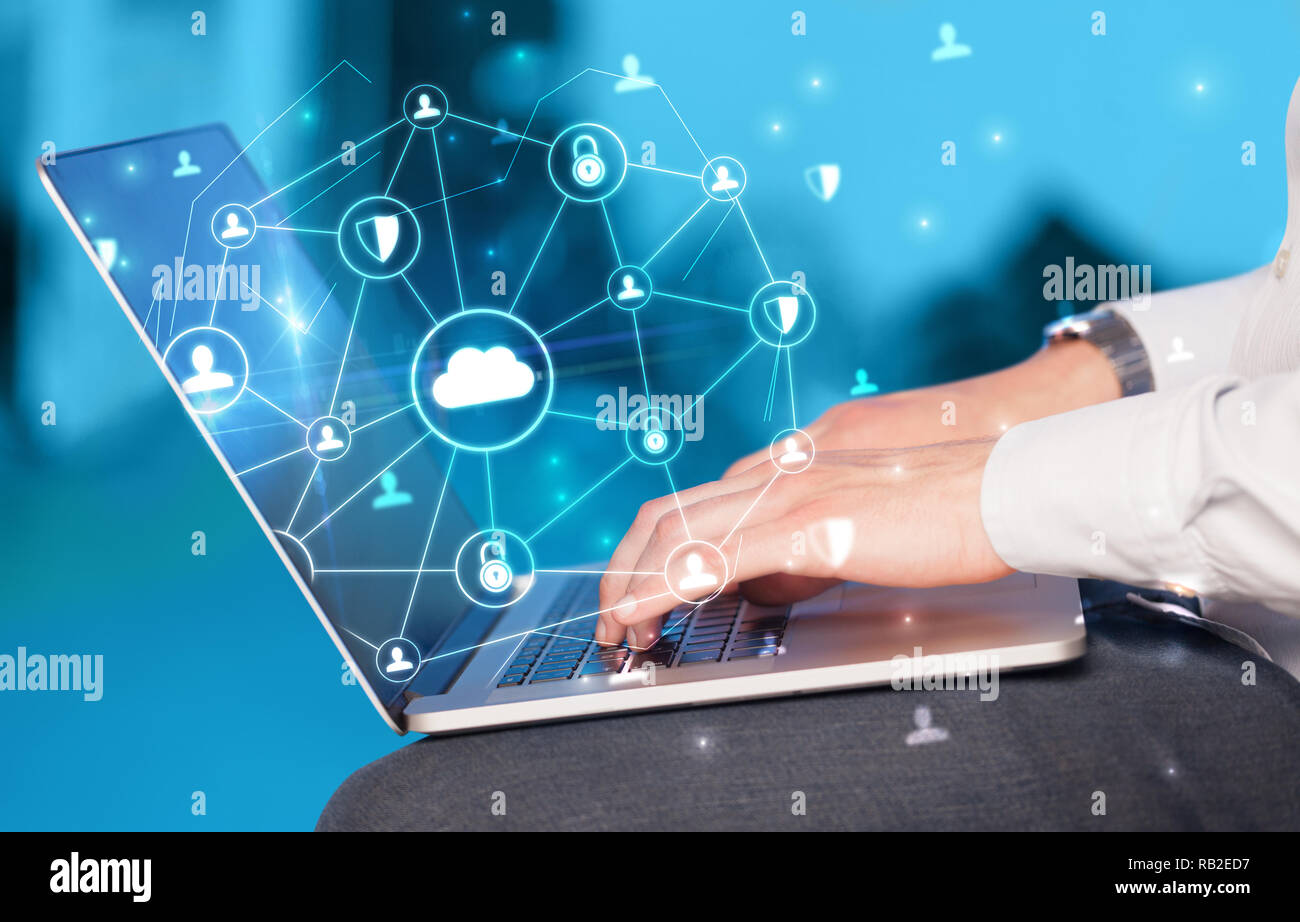 Hand using laptop with centralized cloud computing system and network ...