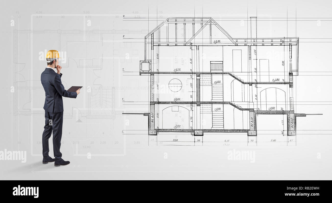 Architect watching a 2 dimension house plan Stock Photo - Alamy