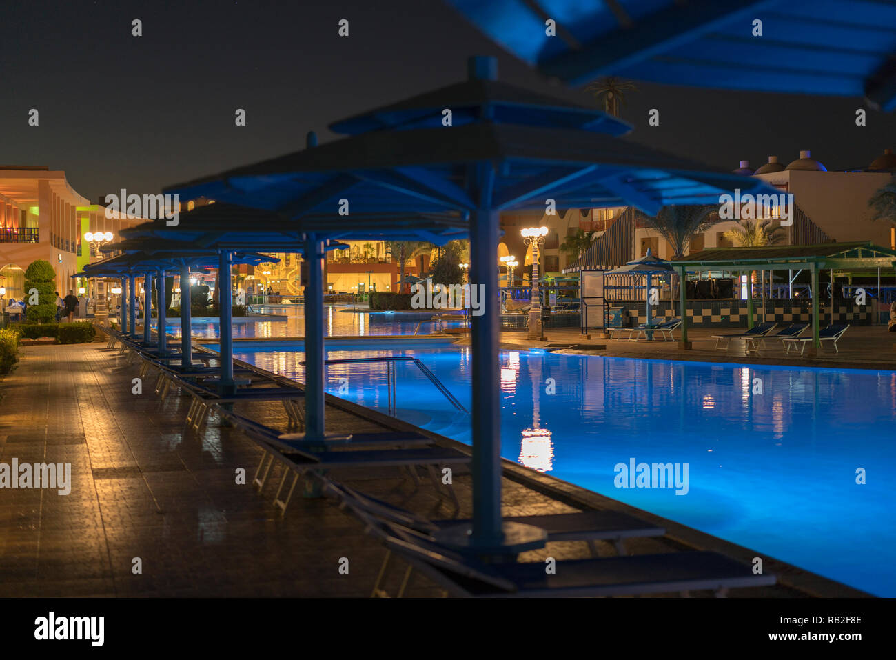 luxury resort with pool at night view. hotel outdoor landscape with ...