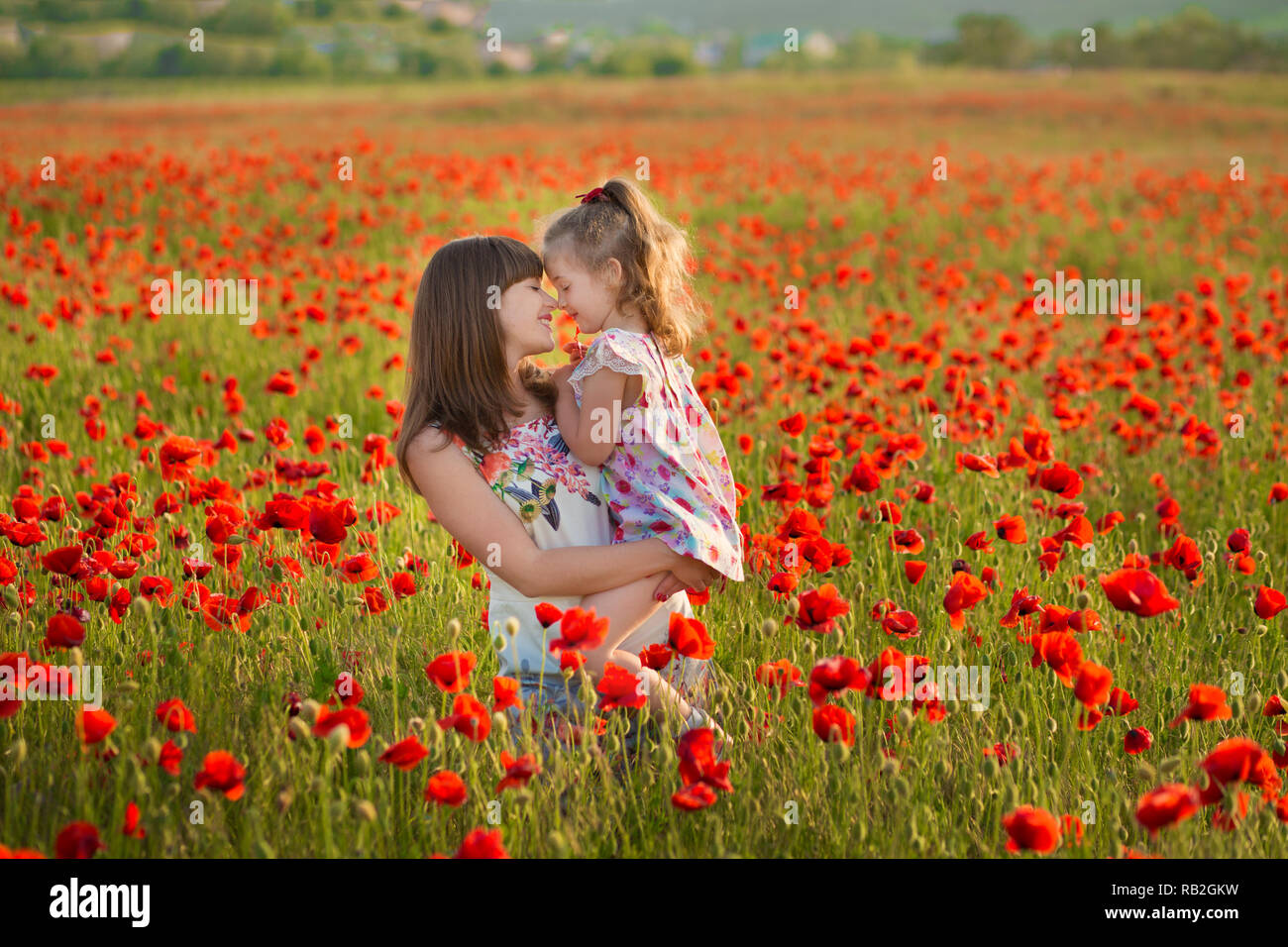 Mother and daughter smiling in a poppy field. The Picnic in the poppy ...