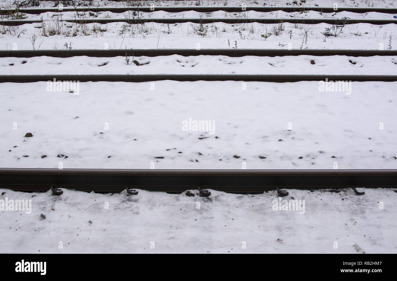 Horizontal railroad tracks in snow and daylight Stock Photo - Alamy
