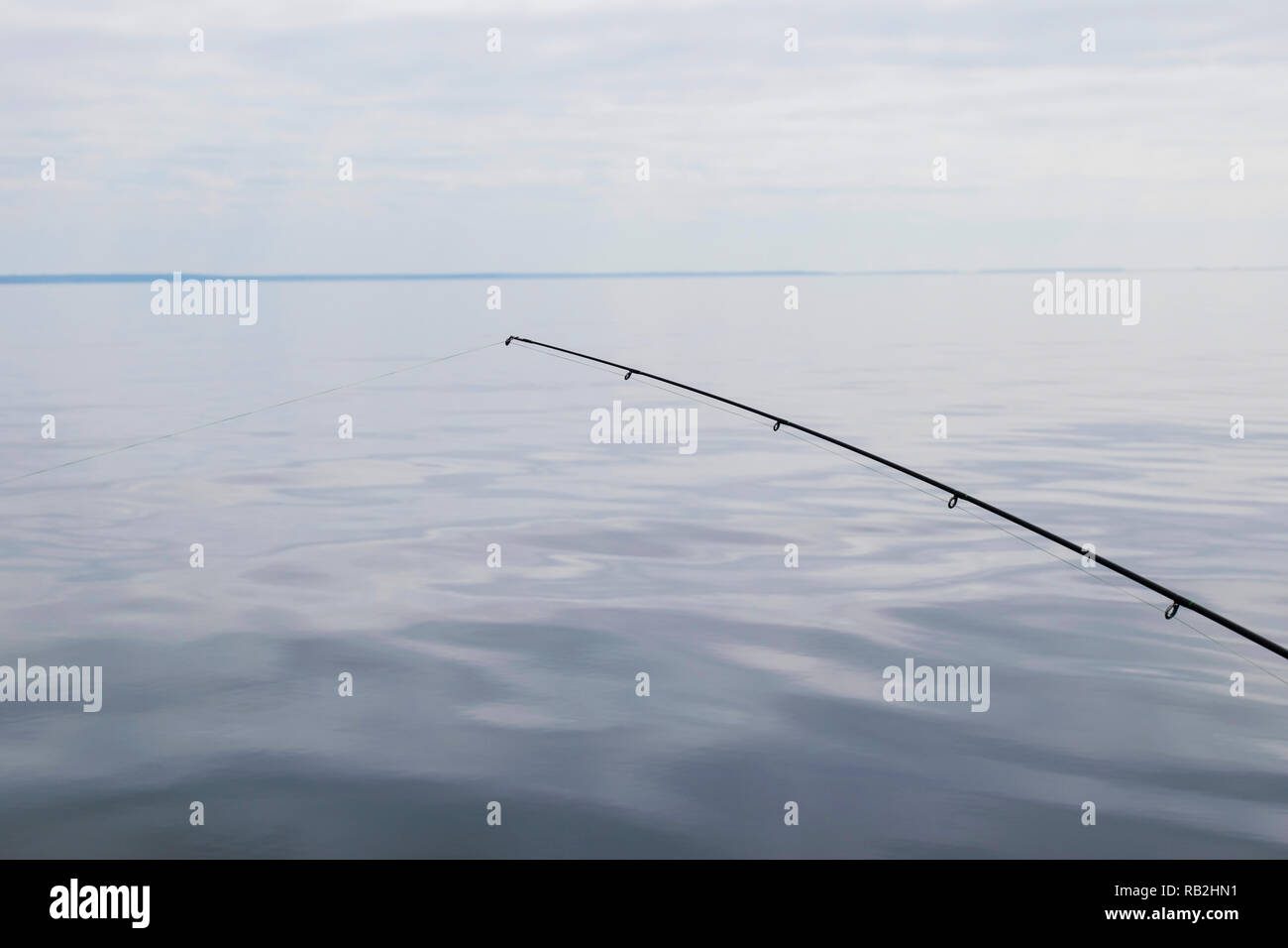 Boat fishing rod with the line over a beautiful cloudy seascape Stock ...