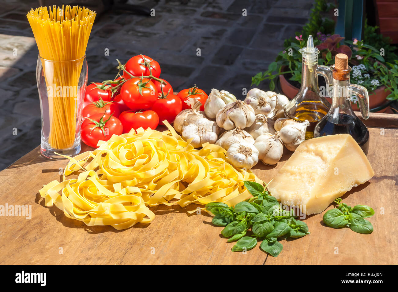 Sunlit table of Italian pasta basic ingredients around - italian ...